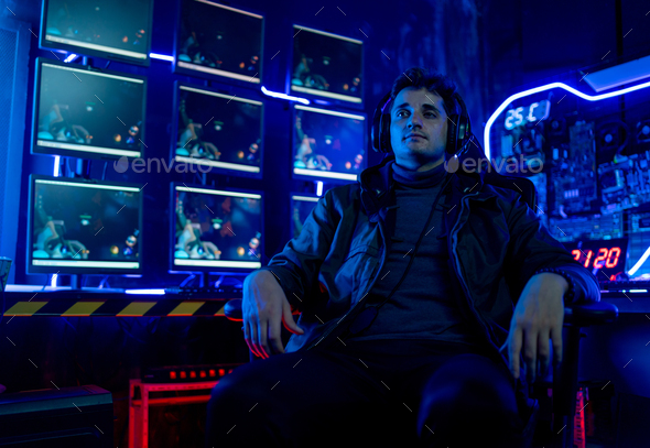 Caucasian gamer man sit with relax on chair and look forward with ...