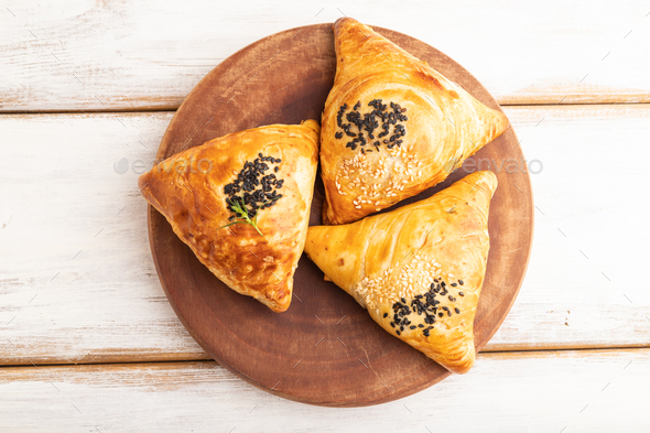 Homemade asian pastry samosa on white wooden. top view. Stock Photo by ...