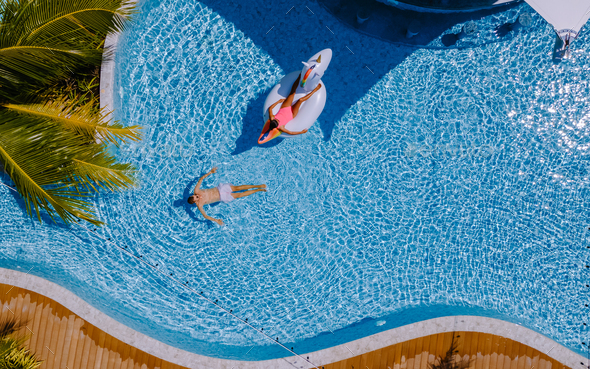 View from above at a swimming pool, couple men and women in swimming ...