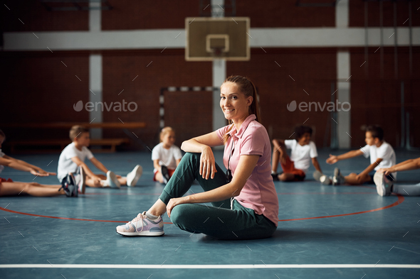 Happy physical education teacher with group of students in the ...