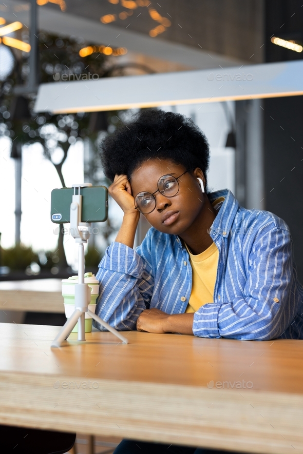 a woman is sad, bored and communicates via video link or with a teache ...