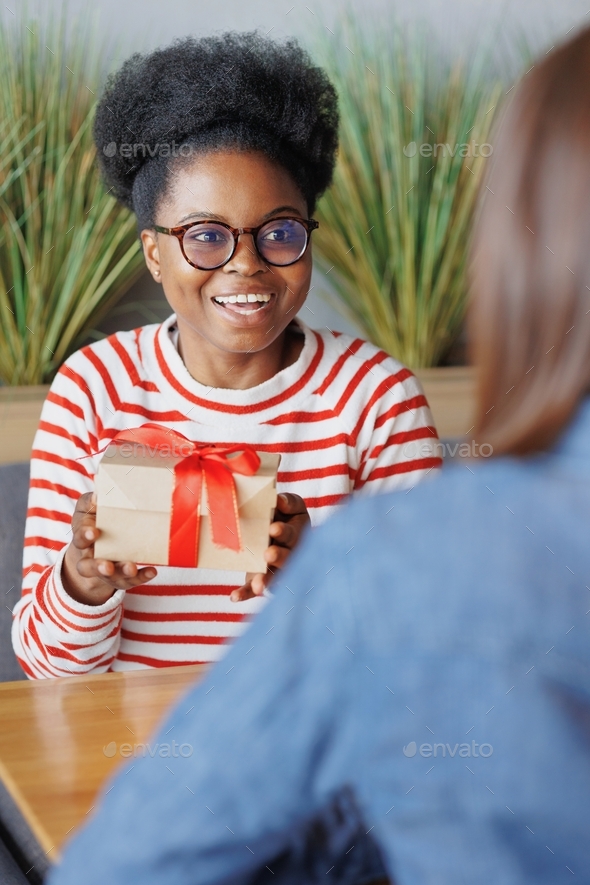 a young and beautiful black woman with glasses and a beautiful smile ...