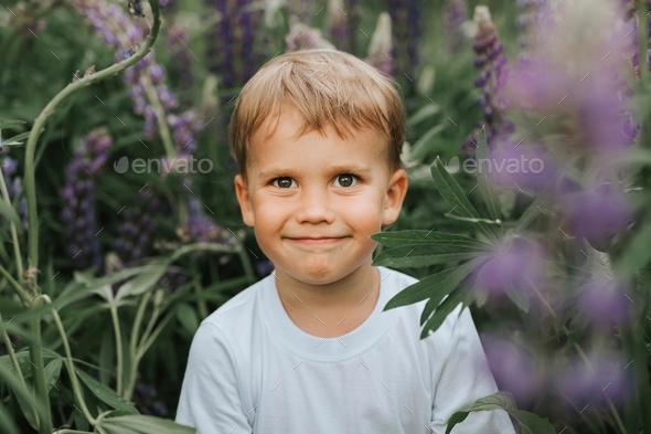 portrait of a cute little happy four year old kid boy with bloom ...
