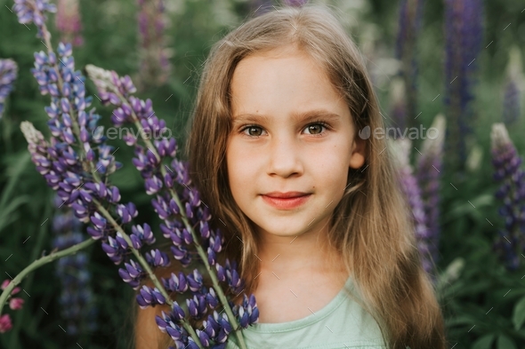 portrait of a cute little happy seven year old kid girl with bloom ...