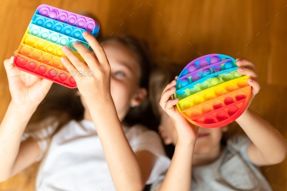 anti stress sensory pop it toys in a children's hands. a little happy ...