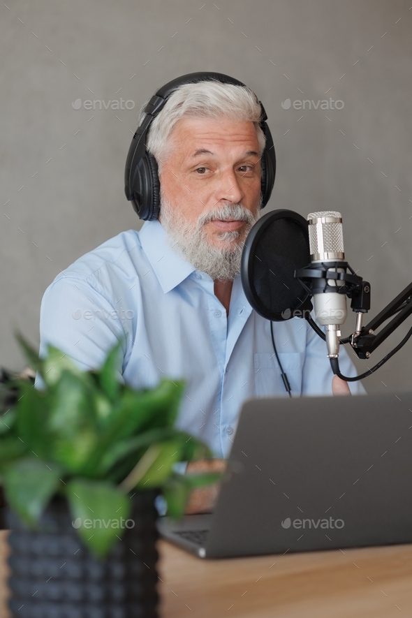senior businessman. an adult European man with gray hair is a radio ...