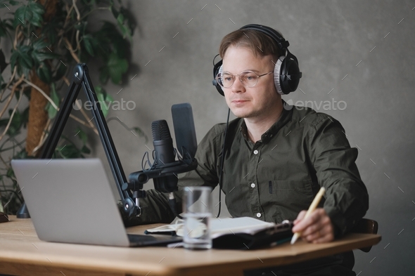 male podcaster in a recording studio or on the radio with a microphone ...