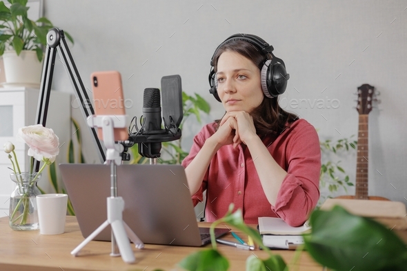 female radio presenter with a microphone and headphones. millennial ...
