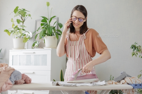 laundry or wash them at home. a young European housewife is engaged in ...