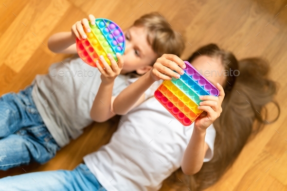 anti stress sensory pop it toys in a children's hands. a little happy ...