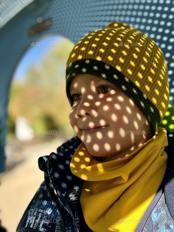 portrait little kid boy with shadow and sunlight on face. children in ...