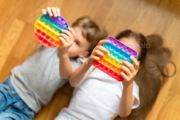 anti stress sensory pop it toys in a children's hands. a little happy ...