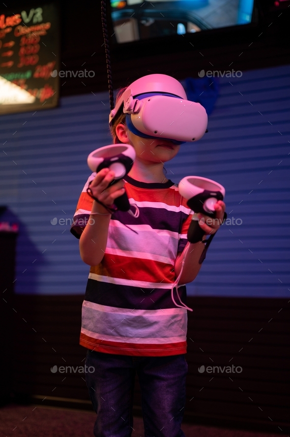 vr game and virtual reality. kid boy gamer gen z in 3d glasses playing ...