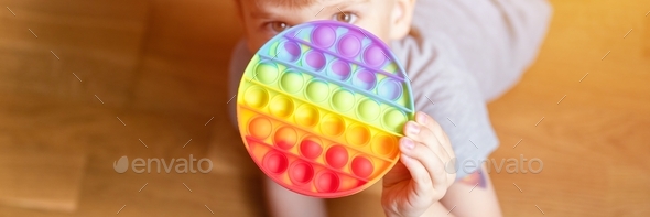 anti stress sensory pop it toys in a children's hands. a little happy ...