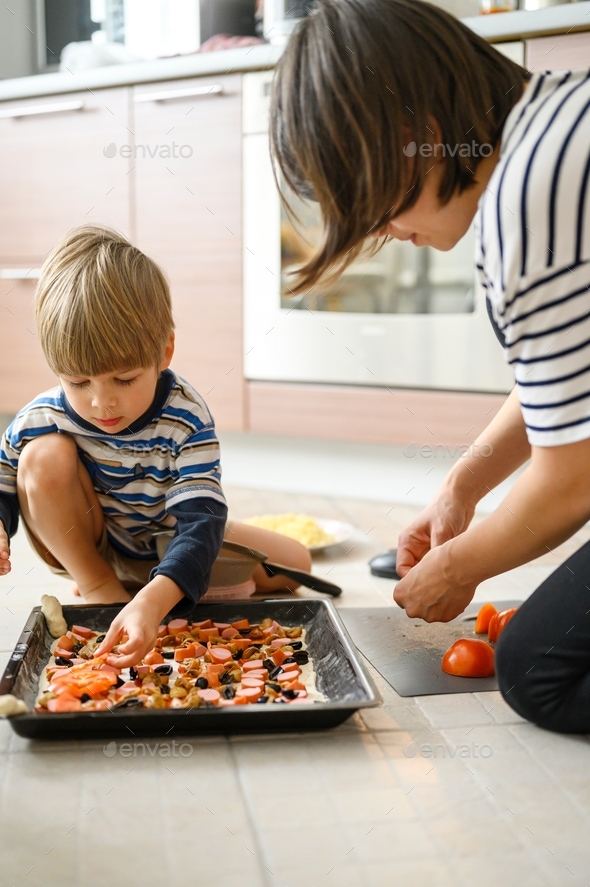 happy family make food at home. mom together her kid son toddler ...