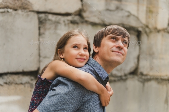 dad and kid daughter hug on arms. happy father playing child. authentic ...