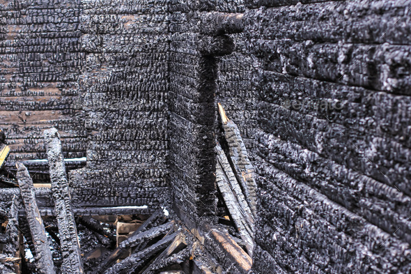 The burnt frame of the private village wooden house. Burnt wood texture ...