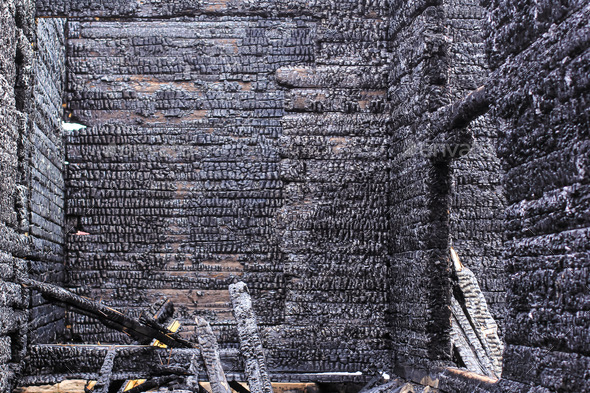 The burnt frame of the private village wooden house. Burnt wood texture ...
