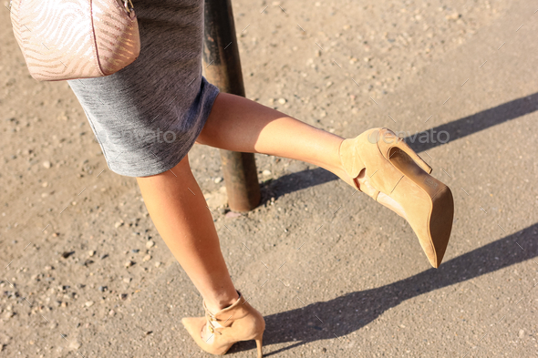 Broken stiletto heel on the shoes wearing by attractive young woman. N ...