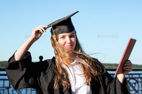 Cute teenage graduate girl laughing and having fun. No school, back to ...