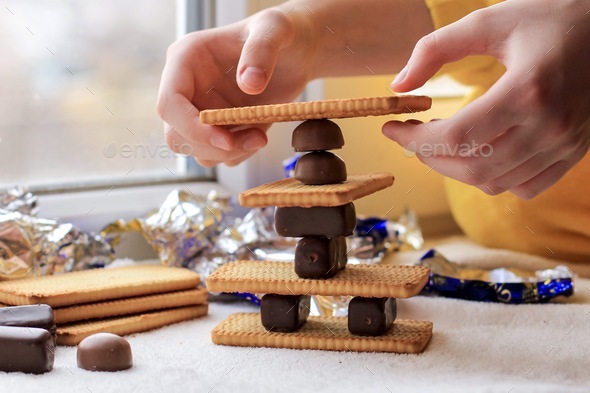 A pyramid of cookies and candies built by a teenage girl bored during ...