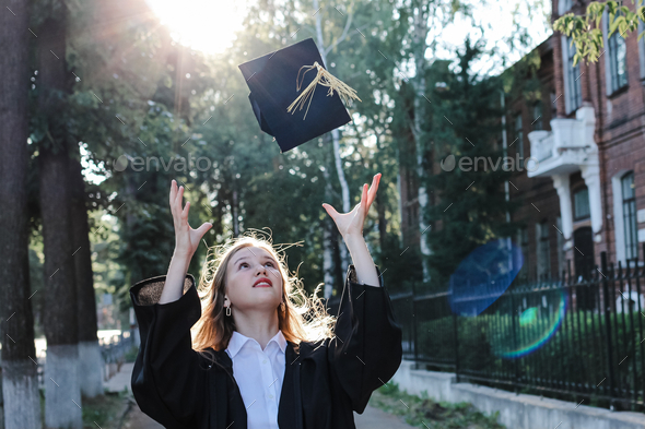 Cute teenage graduate girl laughing and having fun. No school, back to ...