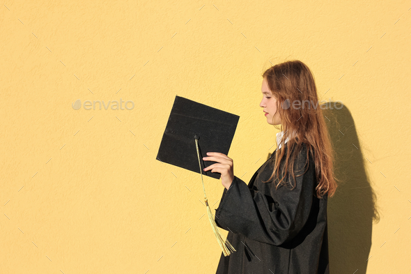 Cute teenage graduate girl laughing and having fun. No school, back to ...