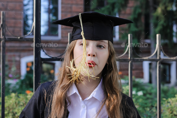 Cute teenage graduate girl laughing and having fun. No school, back to ...