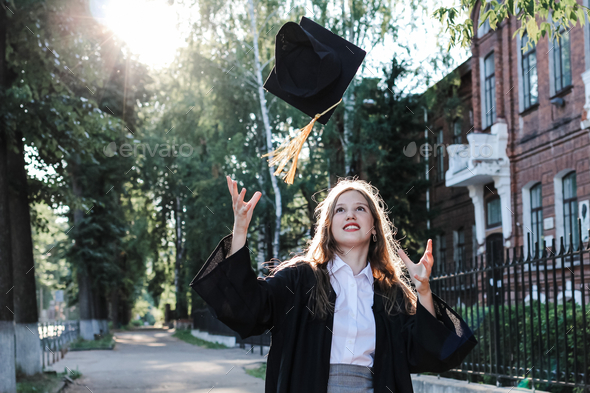 Cute teenage graduate girl laughing and having fun. No school, back to ...
