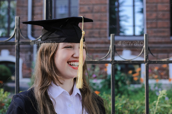 Cute teenage graduate girl laughing and having fun. No school, back to ...