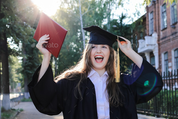 Cute teenage graduate girl laughing and having fun. No school, back to ...