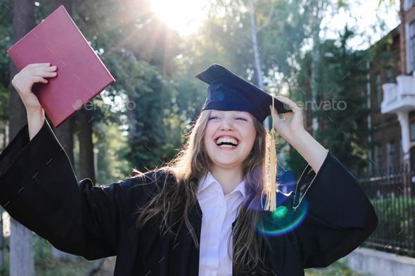 Cute teenage graduate girl laughing and having fun. No school, back to ...