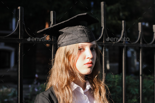 Cute teenage graduate girl laughing and having fun. No school, back to ...