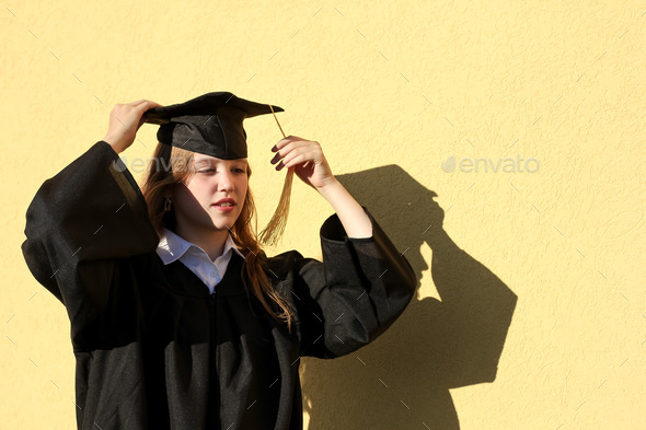 Cute teenage graduate girl laughing and having fun. No school, back to ...