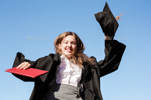 Cute teenage graduate girl laughing and having fun. No school, back to ...