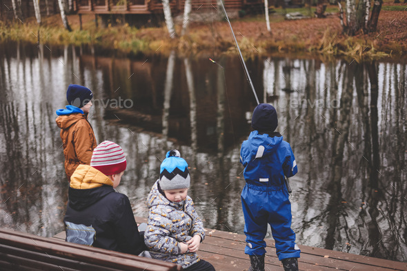 Diverse group of people, boys of different ages friends fishing on lake ...