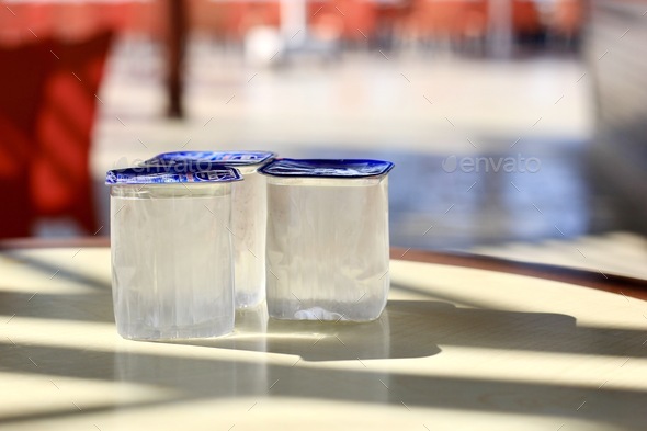 Drinking water packed in rectangular plastic cups. The unusual shape of ...