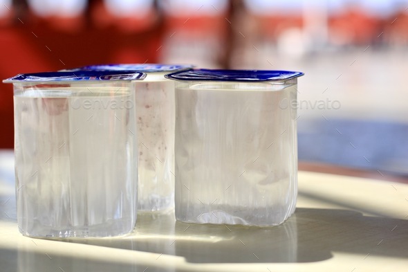 Drinking water packed in rectangular plastic cups. The unusual shape of ...