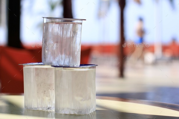 Drinking water packed in rectangular plastic cups. The unusual shape of ...
