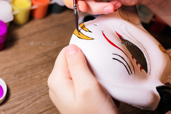 A teenage girl making a cat mask design. Drawing, creativity, hobby ...