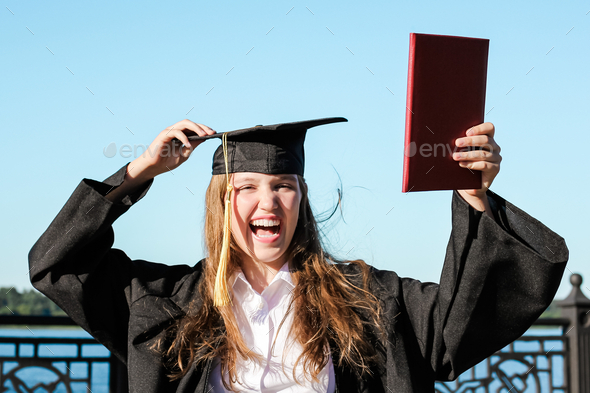 Cute teenage graduate girl laughing and having fun. No school, back to ...