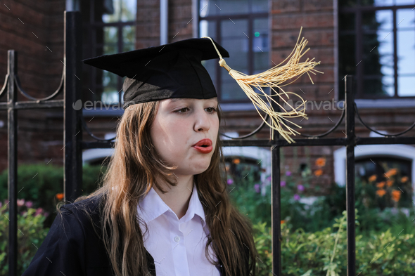 Cute teenage graduate girl laughing and having fun. No school, back to ...