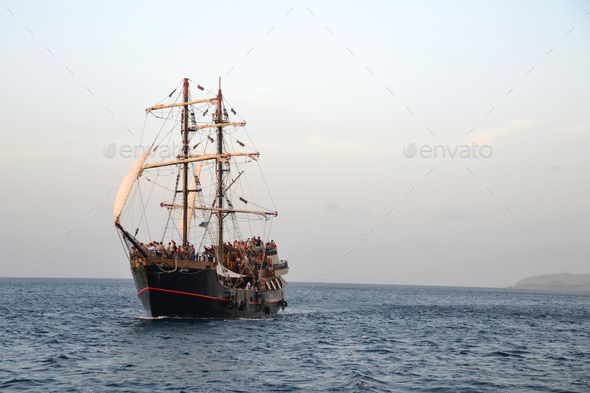 A replica of a Spanish galleon with sails out at sea in the Caribbean ...