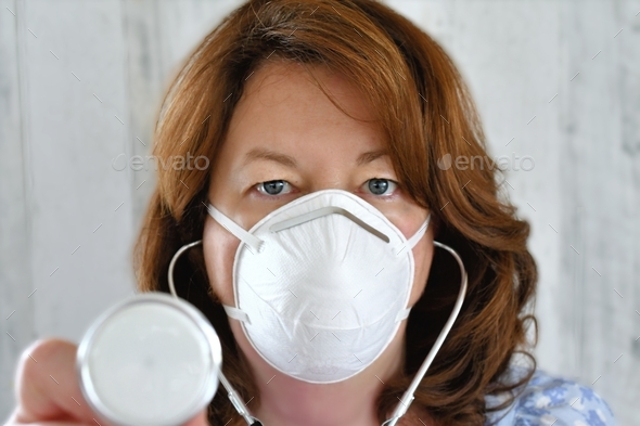 Woman doctor nurse wearing N95 face mask with stethoscope at hospital ...