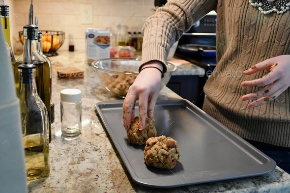 Forming stuffing or dressing balls for the holidays and placing them on ...