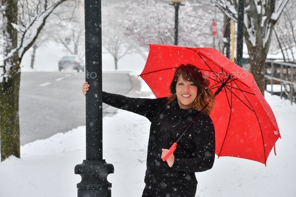 A Puerto Rican Latino woman laughing enjoying a snow day in the city ...
