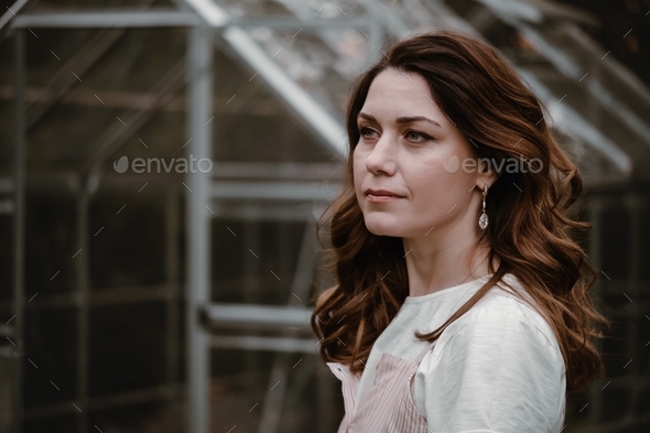 Pretty woman at her 30s in the garden with watering can Stock Photo by ...