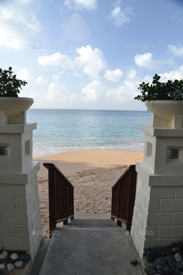 Steps leading through a gate down to the beautiful Caribbean ocean sea ...