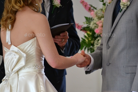 Bride and groom holding hands during the wedding ceremony Stock Photo ...