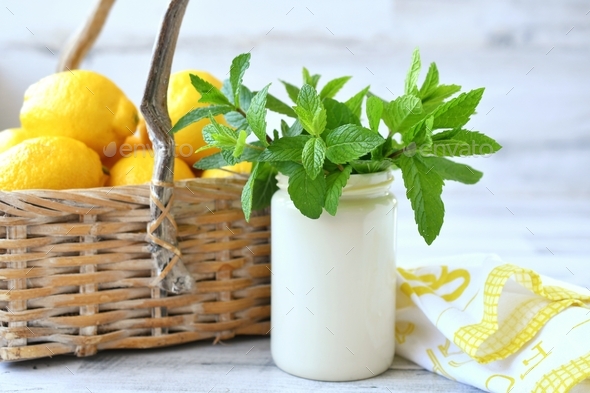A bouquet of mint springs in the kitchen by a basket of lemons, yellow ...
